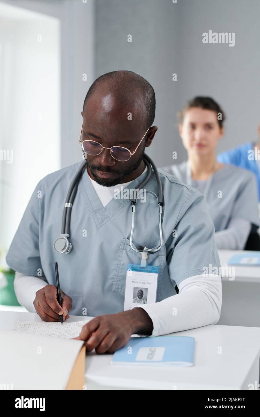 African medical specialist in uniform sitting at a lecture on ...