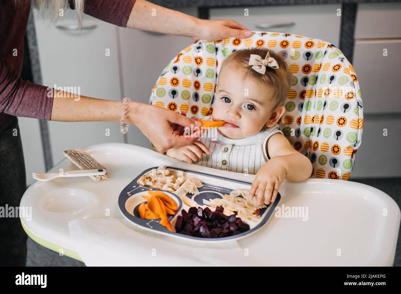 Babys first solid food. Solid food for little child 6 months old. Cute ...