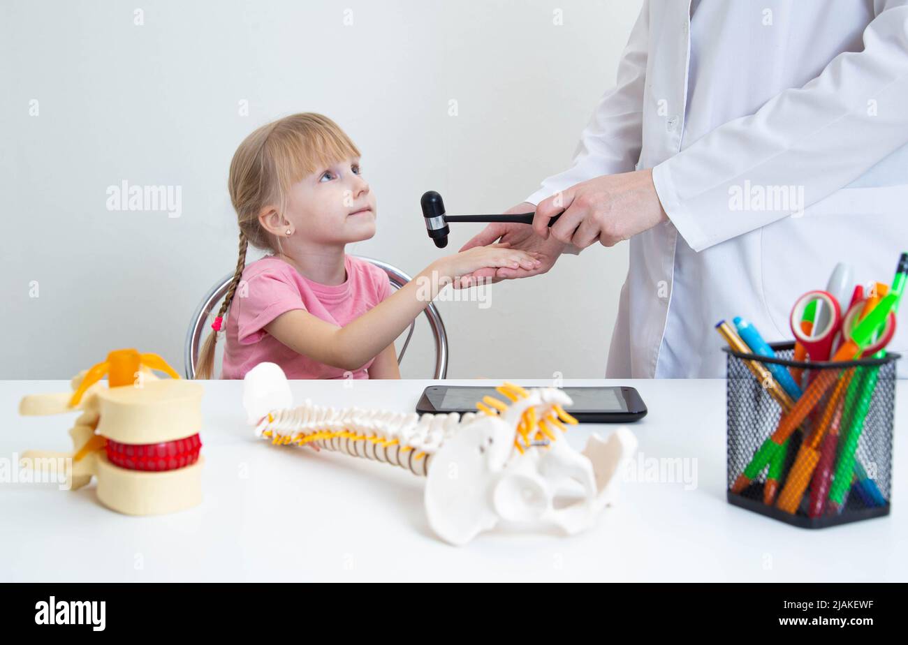 Doctor neuropathologist checks the reflex on the wrist joint with a ...