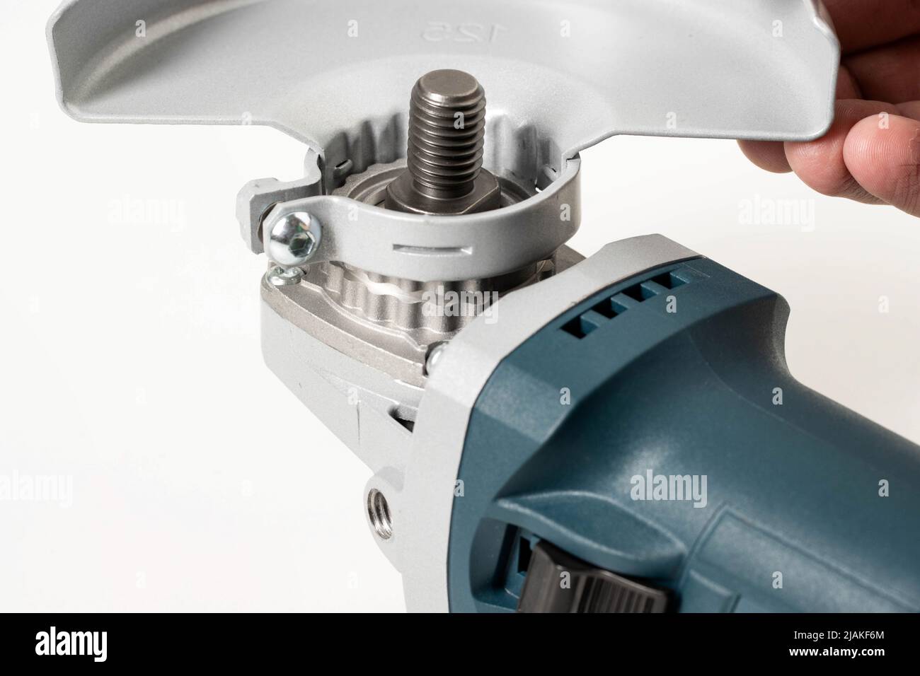 Installing the safety cover on an angle grinder, close-up. Safety ...