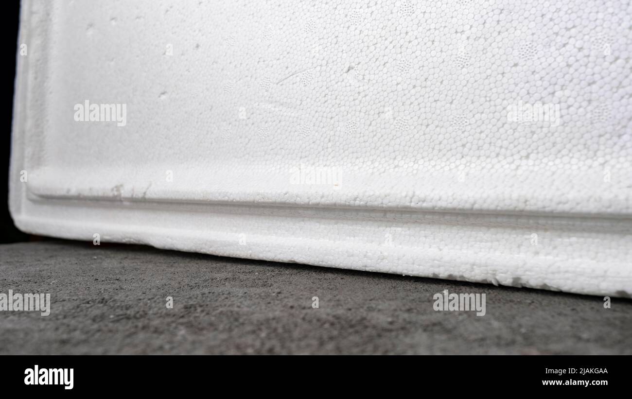 building material styrofoam on gray concrete table, abstract horizontal ...