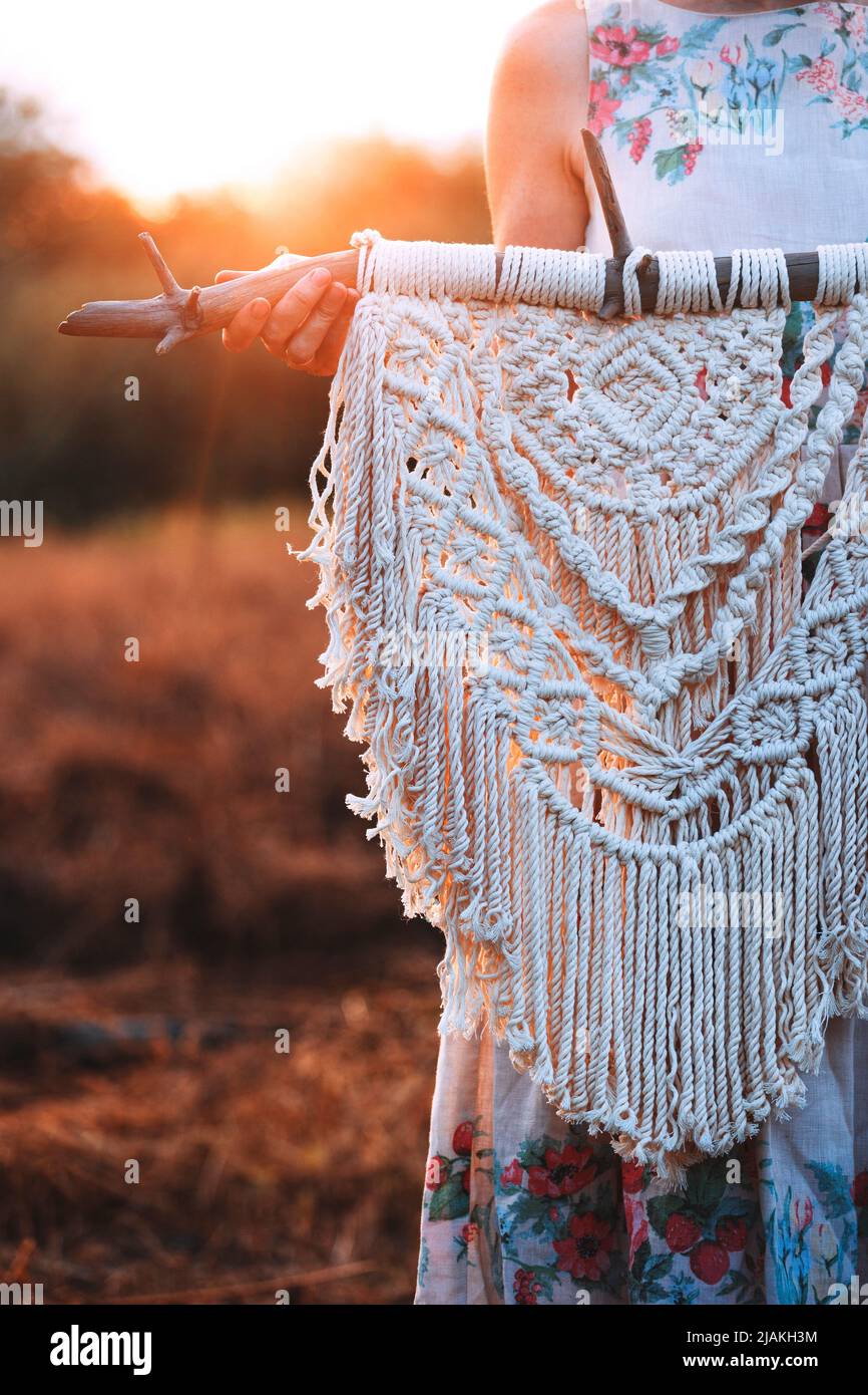 creation of a panel from macrame. girl with macram panel in the sunset ...