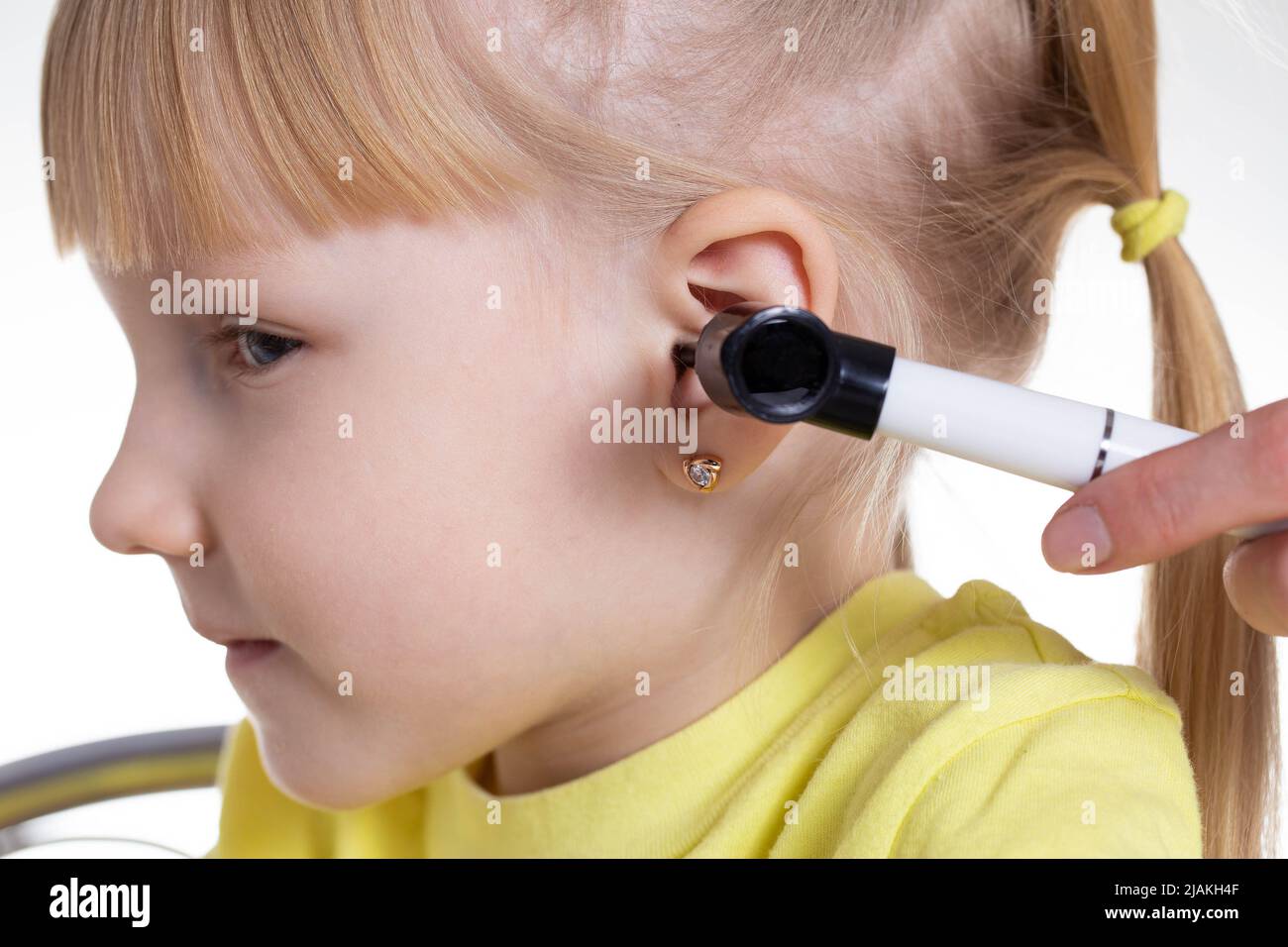 Doctor ENT doctor looks into the ear of a beautiful girl patient at the ...