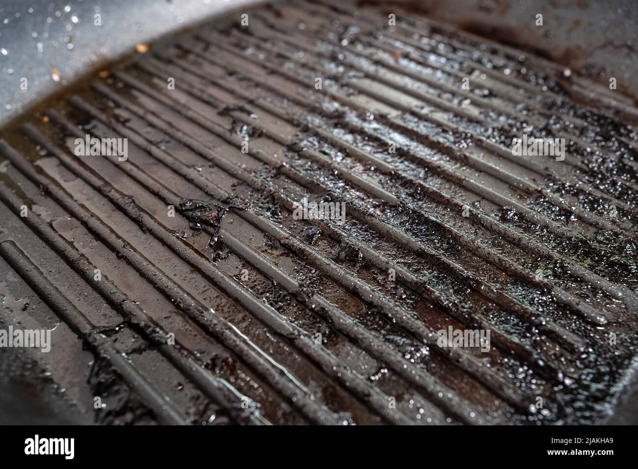 Grill pan with fat deposits after cooking meat. Selective focus ...