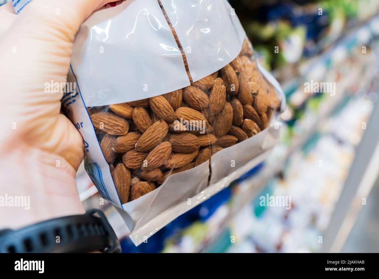 Pre packaged snacks almonds on the shelves of the hypermarket ...