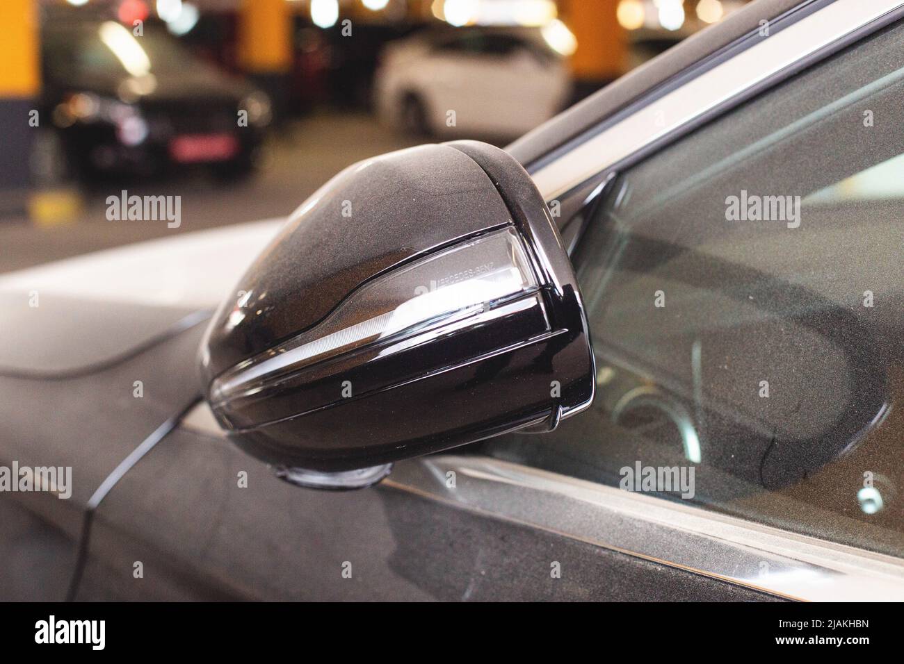 Modern folding car mirror with turn signal. Black car, close-up ...