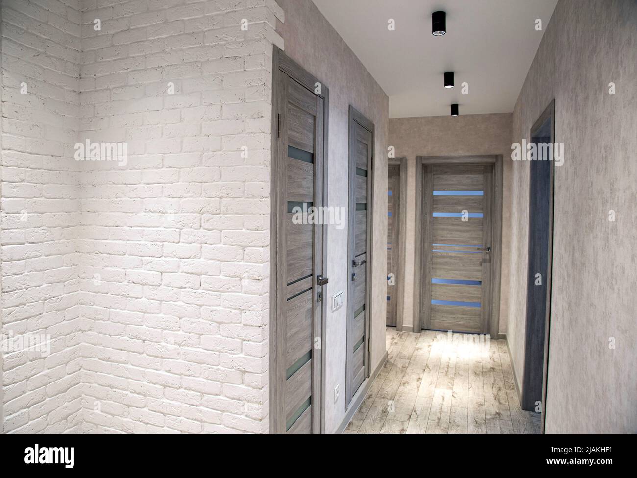 Modern corridor in an apartment after renovation in gray tones. Gray ...