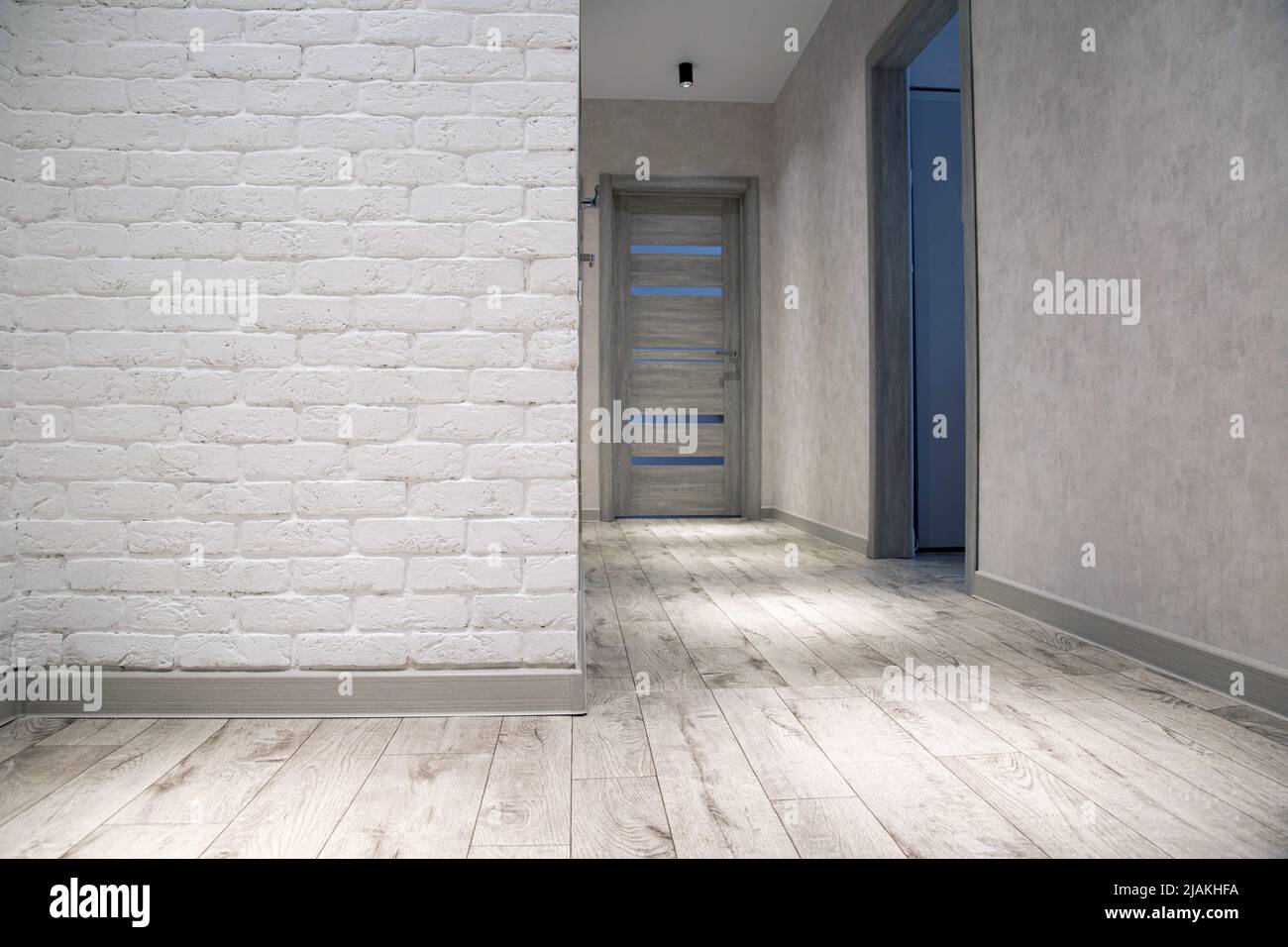 Modern renovation in the hallway, gray linoleum and white brick wall ...