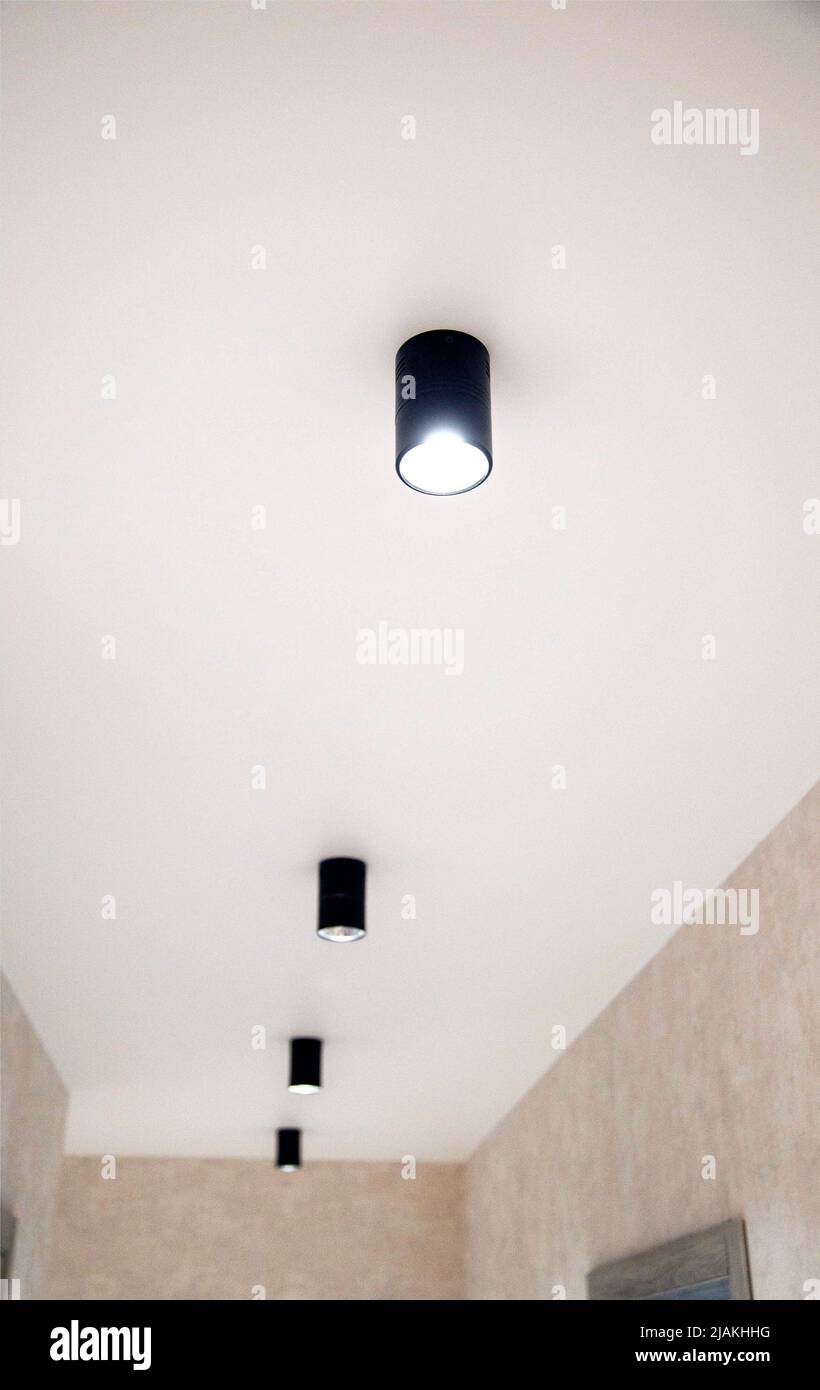 Beautiful black LED lights on the ceiling. Modern stretch ceiling ...