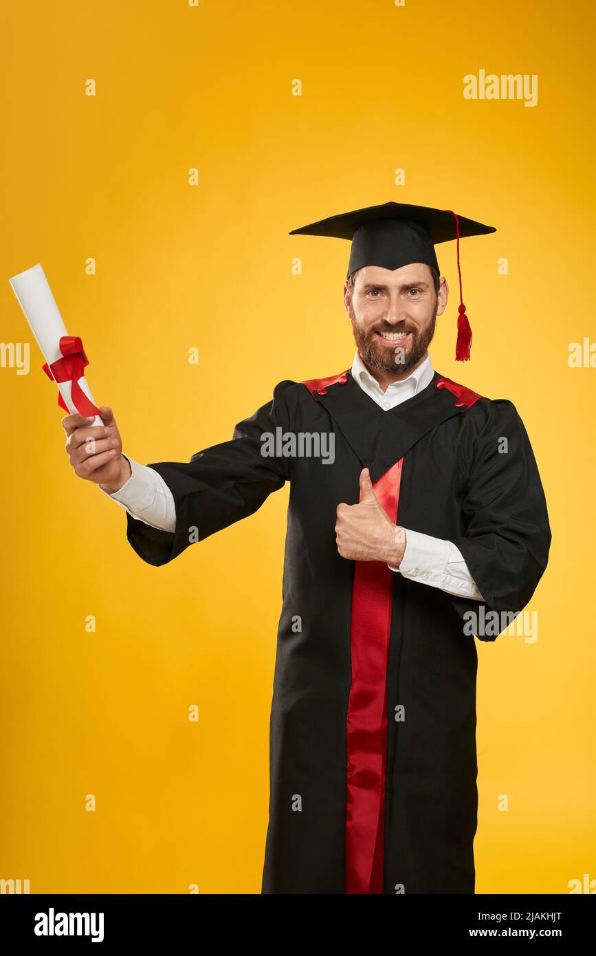 Front view of male student graduating from high school. Handsome man ...
