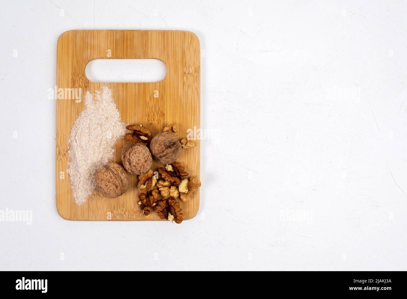 Alternative nut flour made of walnuts nuts, light background. Copy ...