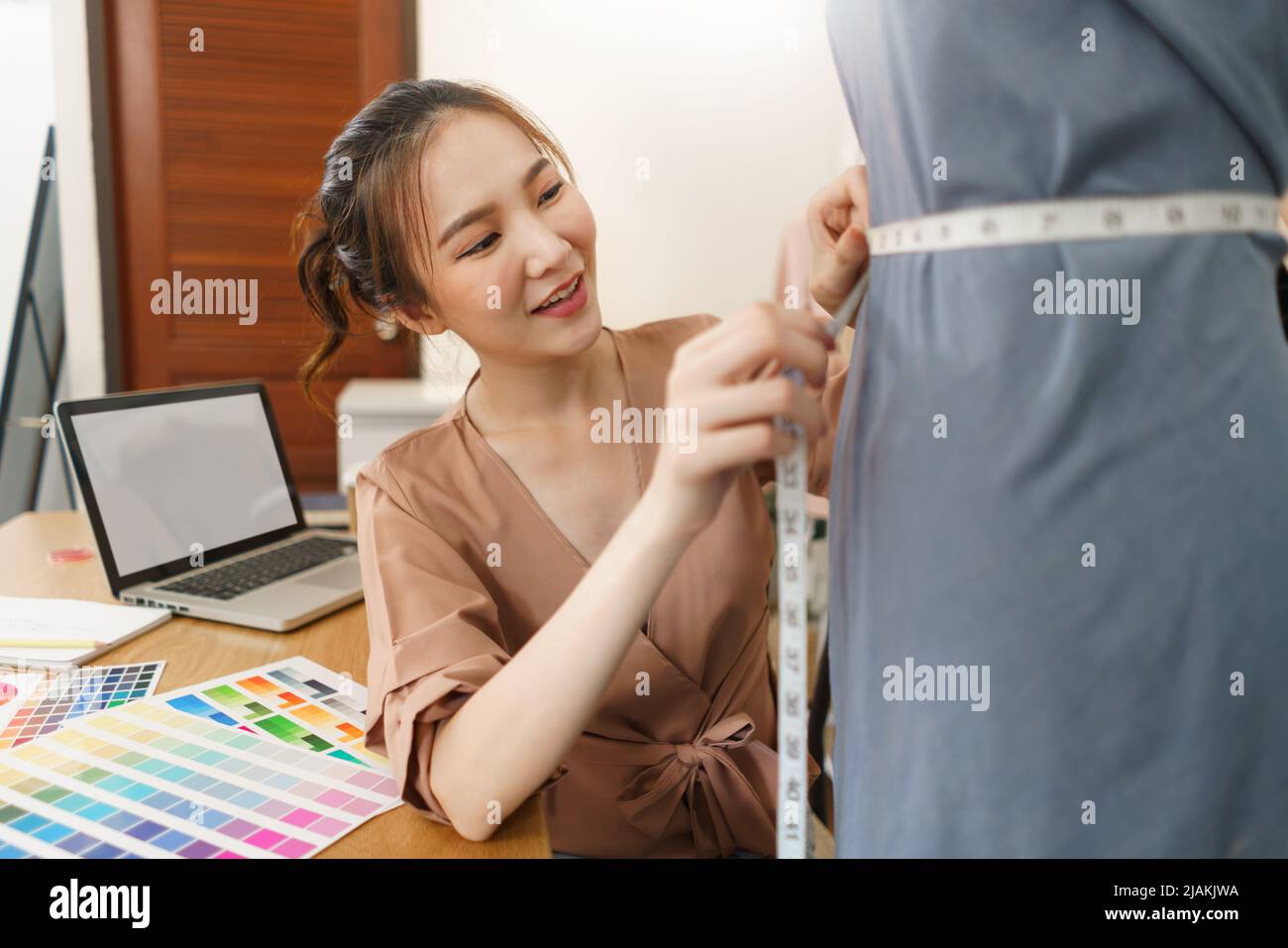 Fashion design concept, Asian female designer use tape measure to ...