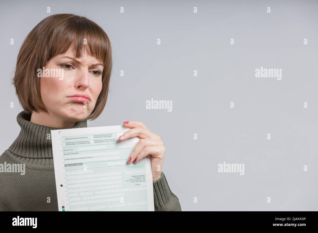 woman with a tax form makes a wry face Stock Photo - Alamy