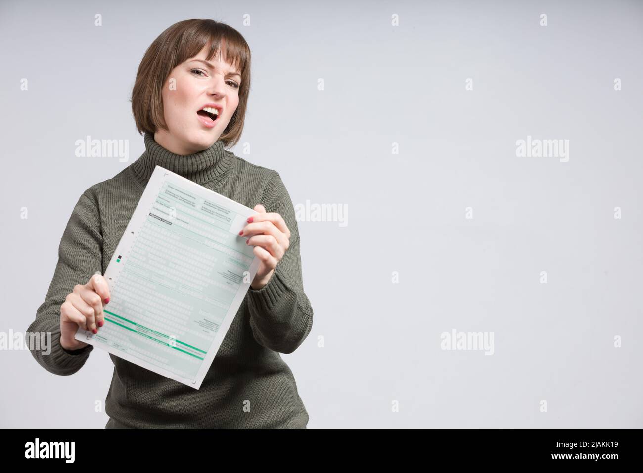 woman with a tax form makes a wry face Stock Photo - Alamy