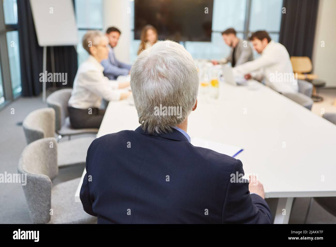 Business man as a boss or manager at the conference table with his team ...
