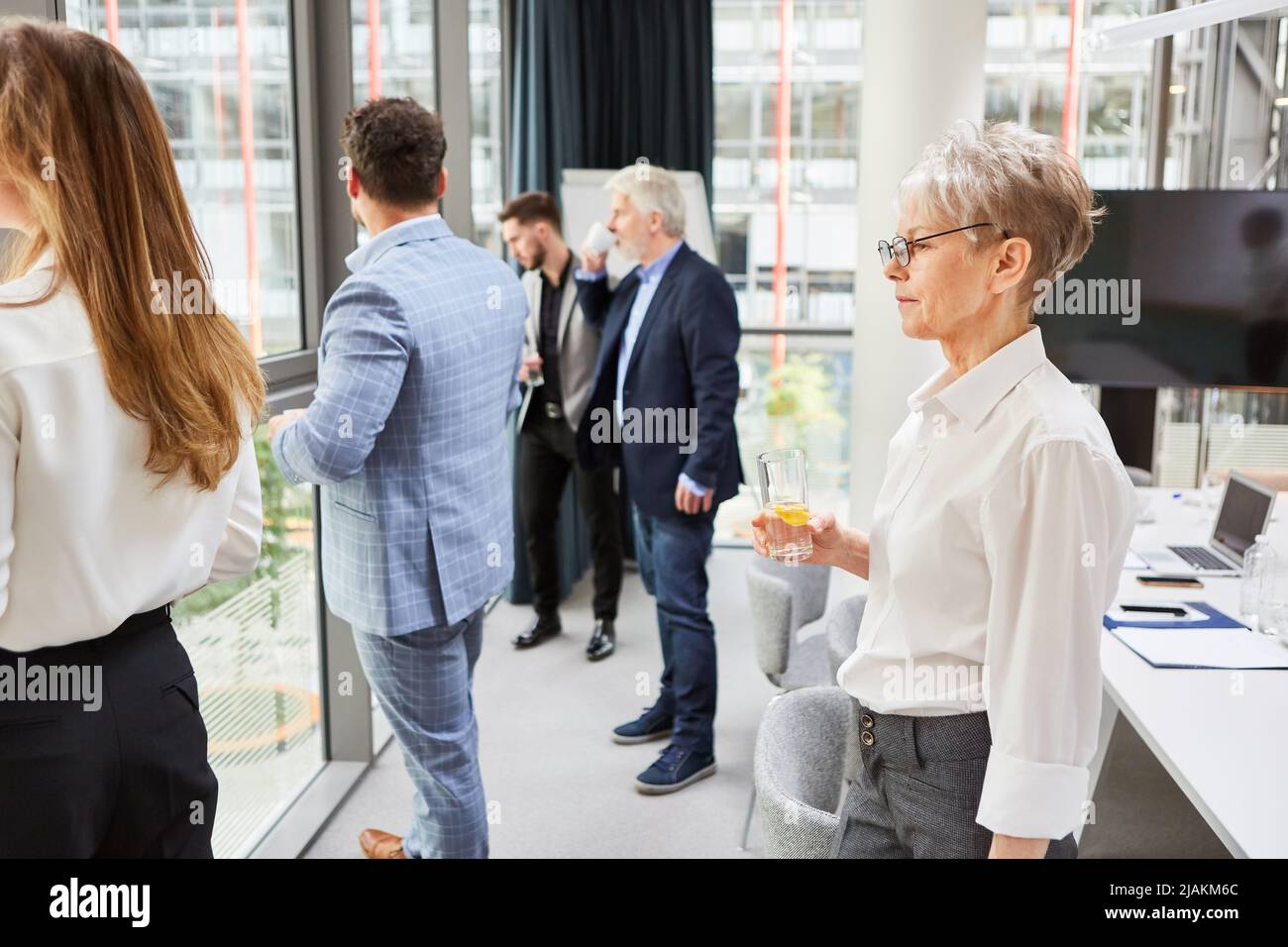 Business team colleagues look relaxed out of the office window during a ...