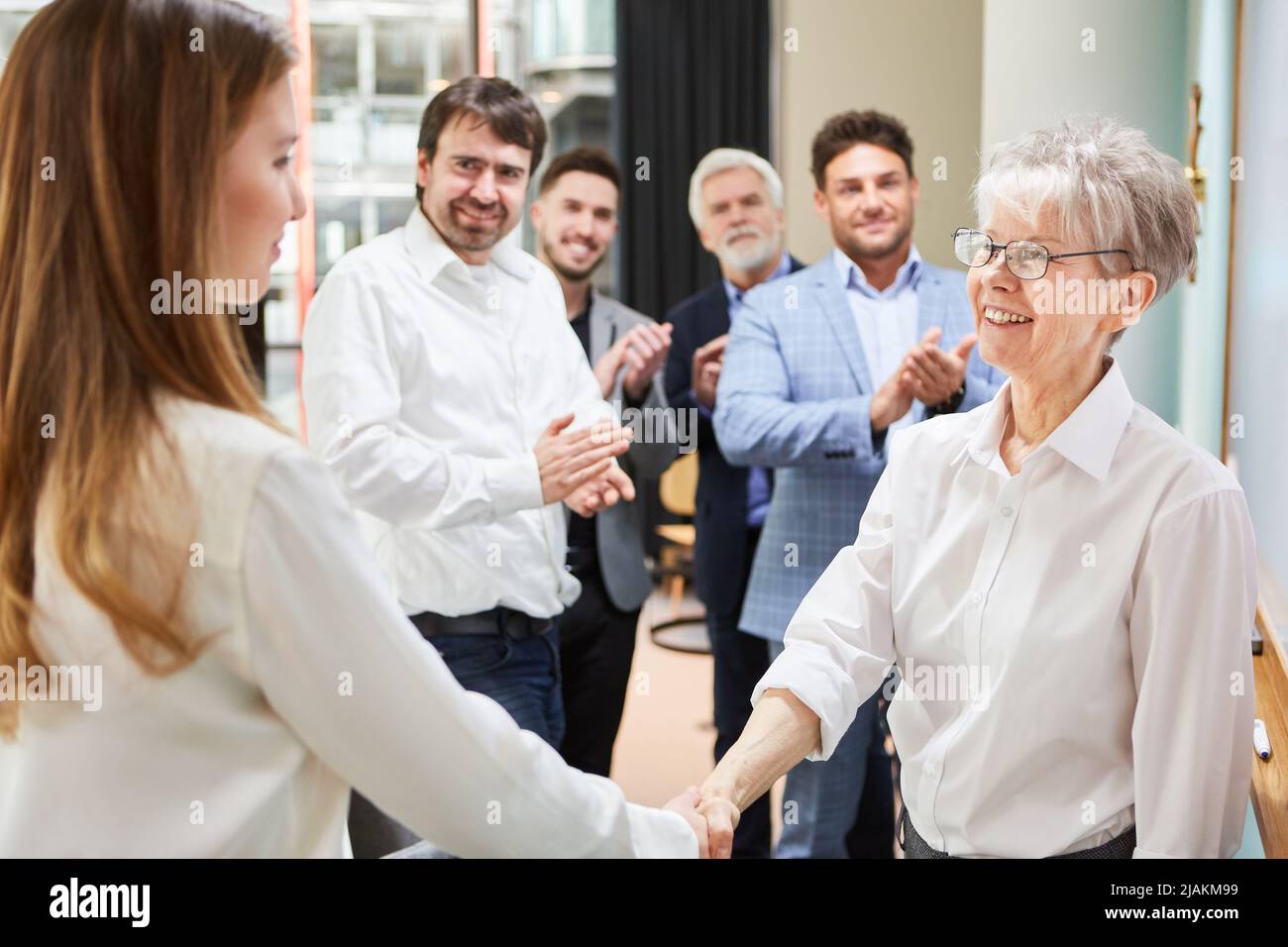 Female boss and trainee shaking hands in the office for congratulations ...