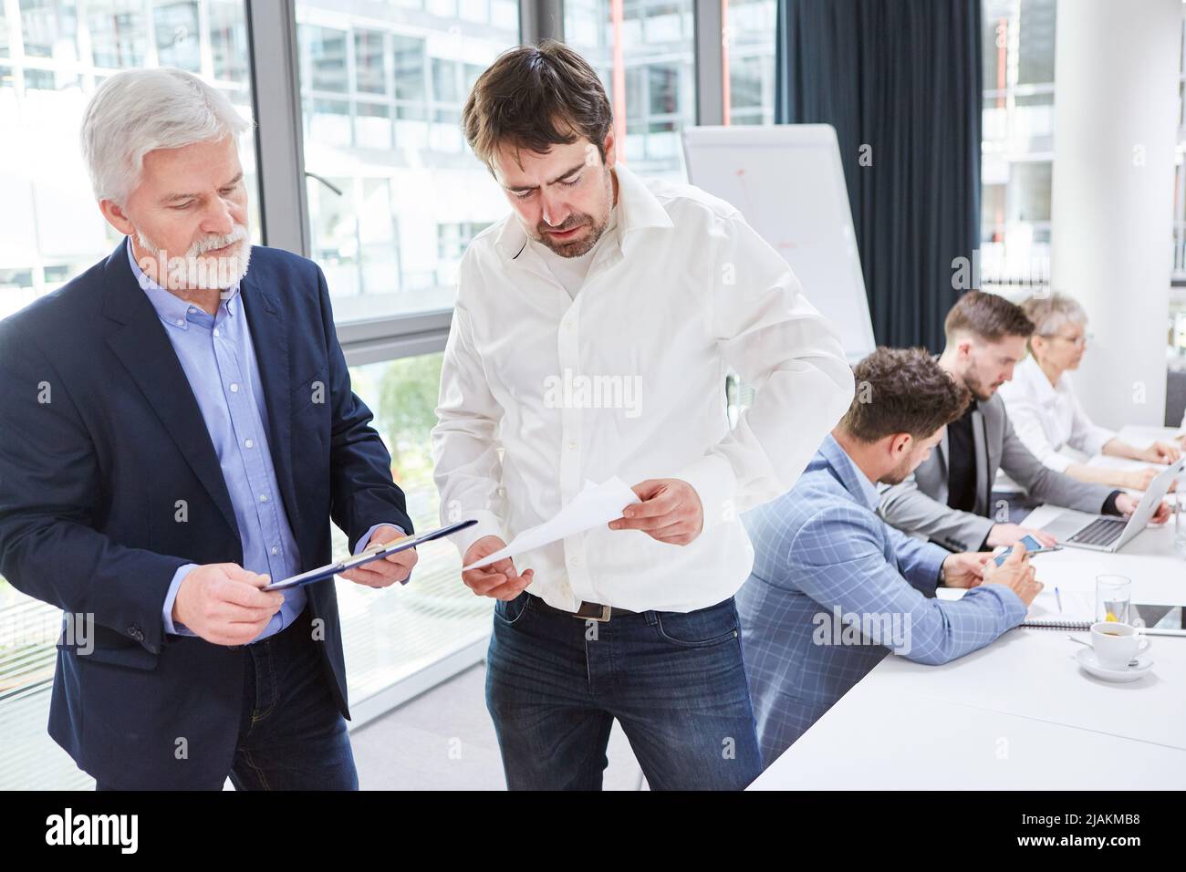 Two businessmen checking and reviewing checklist for a job or project ...