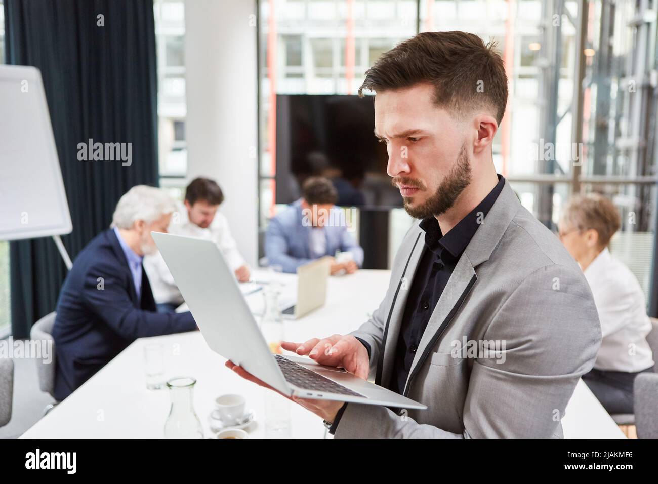 Business man makes a critical research on the laptop computer in the ...