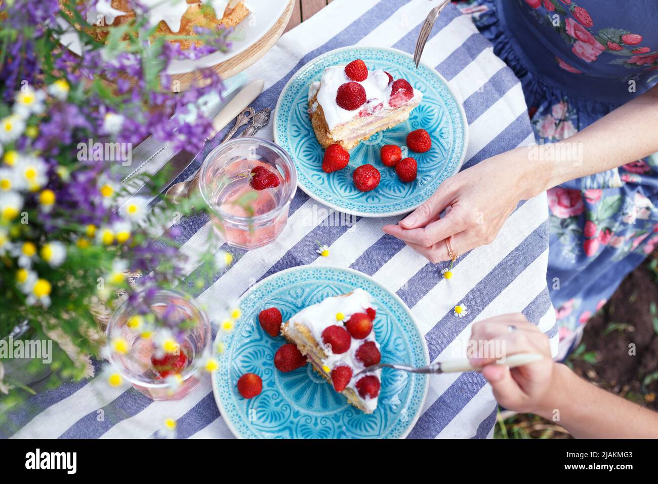 delicious summer. girls eating cake in the garden Stock Photo - Alamy