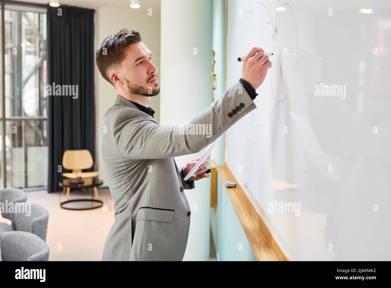 Young lecturer or scientist in a presentation or lecture at the ...