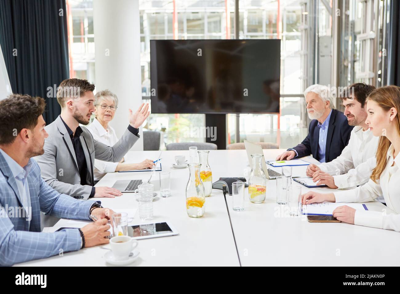 Two business teams at the conference table discussing cooperation and ...
