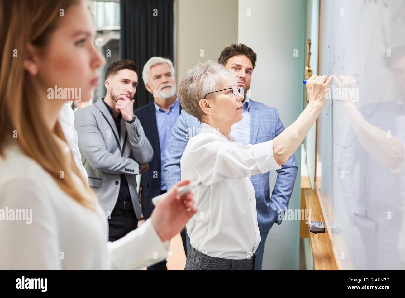 Group brainstorming on whiteboard hi-res stock photography and images ...