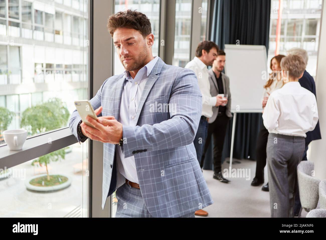 Business man as manager reads messages on smartphone in messenger app ...