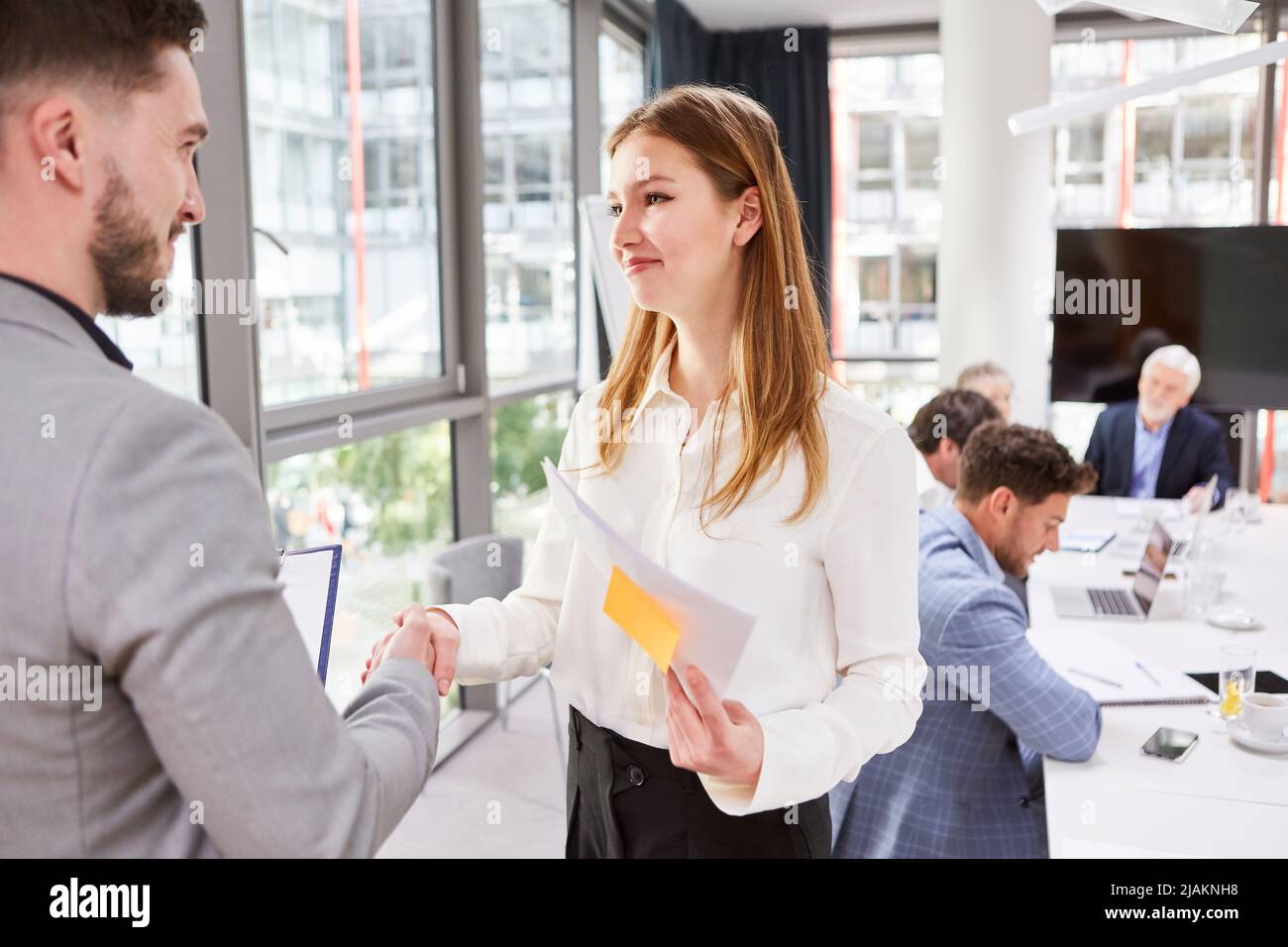 Business man and trainee doing shakehands as a congratulation on ...