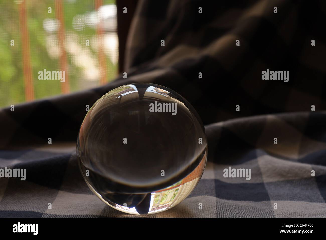 close-up of a glass lens ball on a fabric background Stock Photo - Alamy
