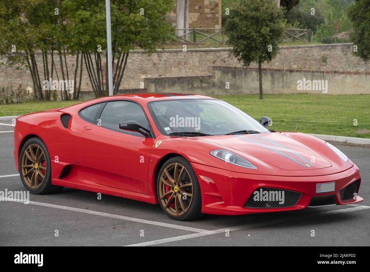 Classic sporty red Ferrari in the parking lot Stock Photo - Alamy