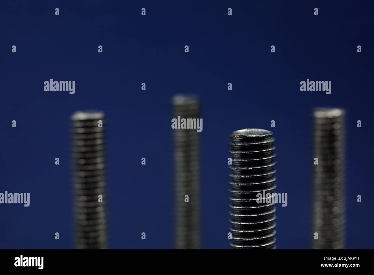 small industrial objects close-up on a blue background Stock Photo - Alamy