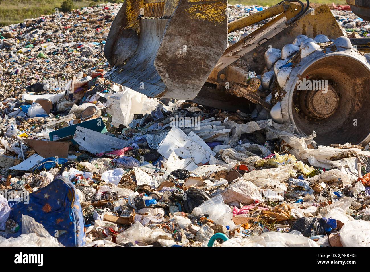 Heavy machinery shredding garbage in an open air landfill. Waste Stock ...