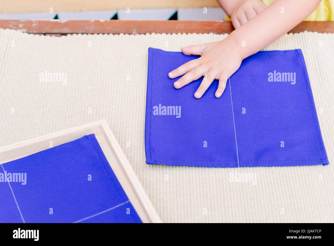 Hands of a girl in a montessori school in the area of daily life ...