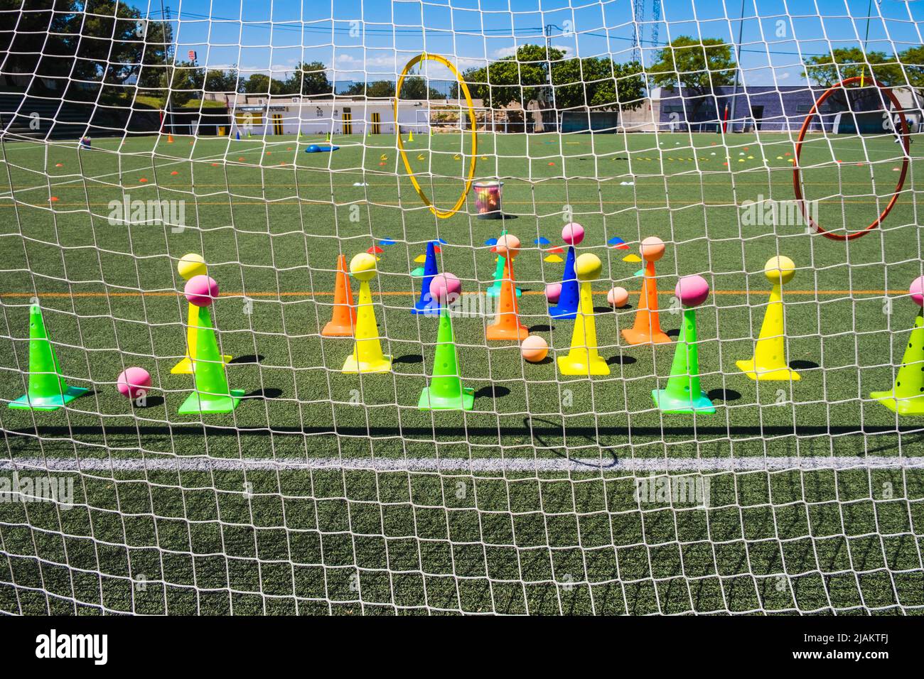 Coaches use plastic cones on the pitch to train younger soccer players ...