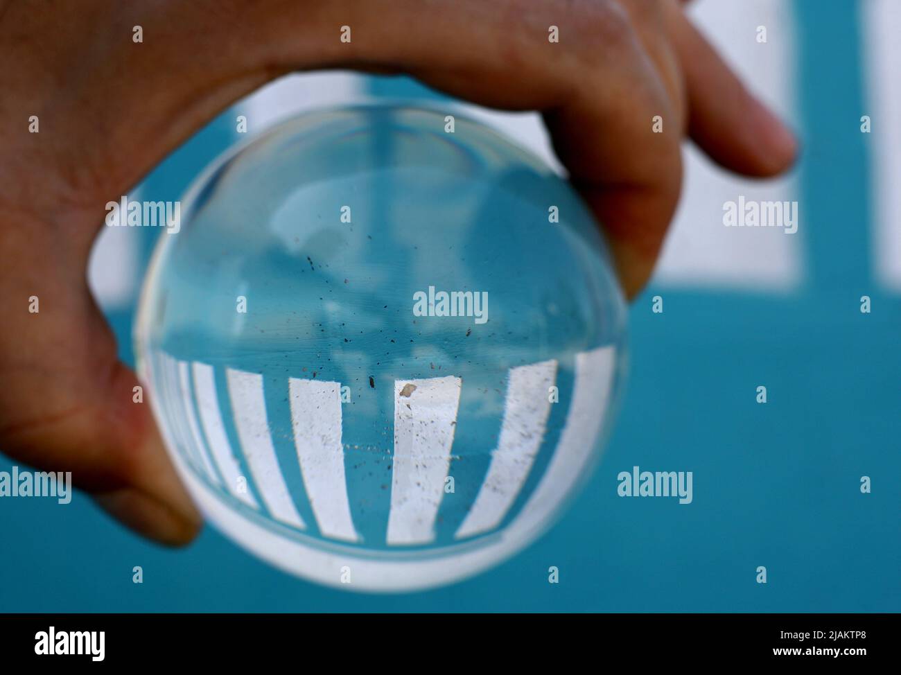 hand holding a glass lens ball Stock Photo - Alamy