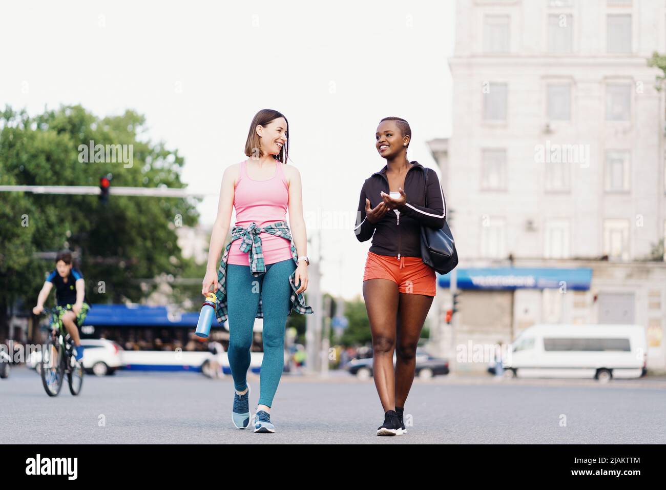 Cheerful smiling friends in sportswear walking after a sport session in ...