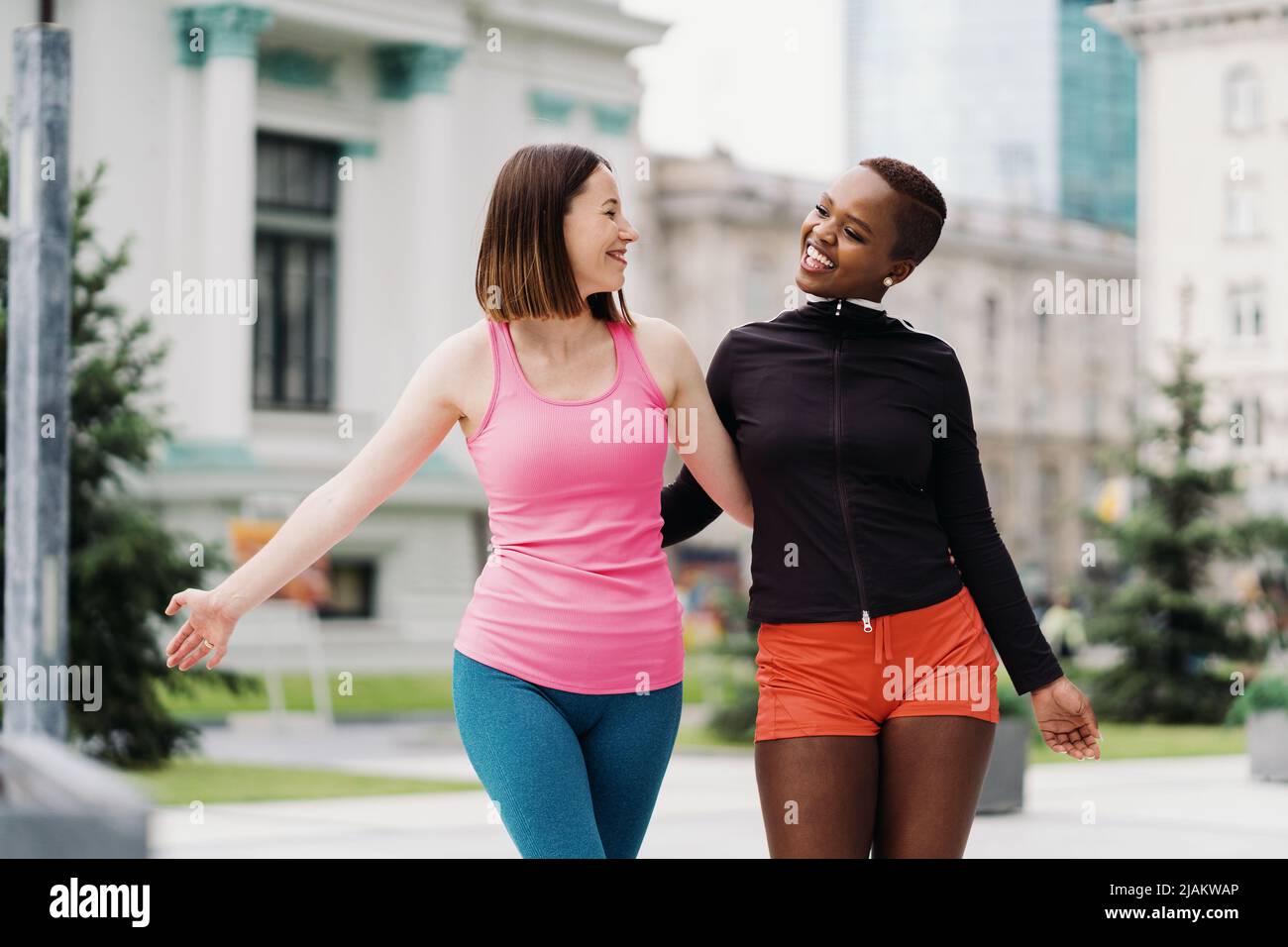 Cheerful smiling friends in sportswear walking after a sport session in ...