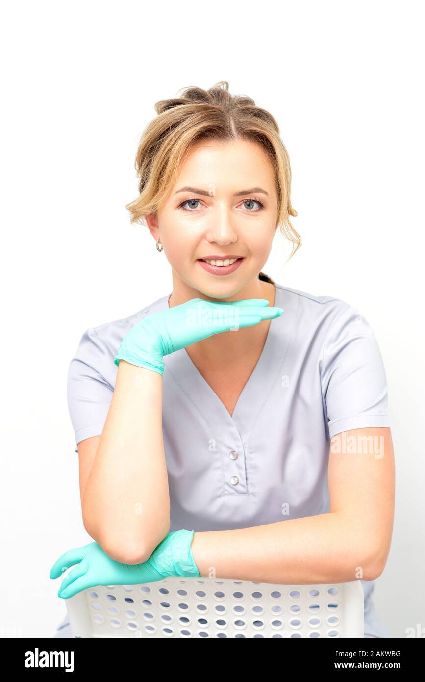 Close-up portrait of young smiling female caucasian healthcare worker ...