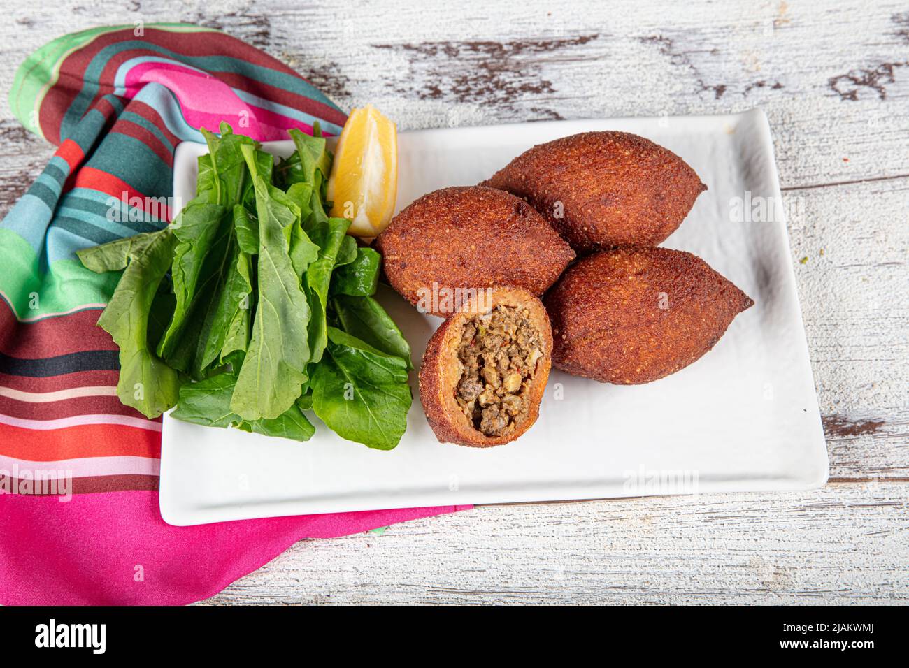 Kibbeh on a white wood background. Kibbeh is a popular dish in Middle ...
