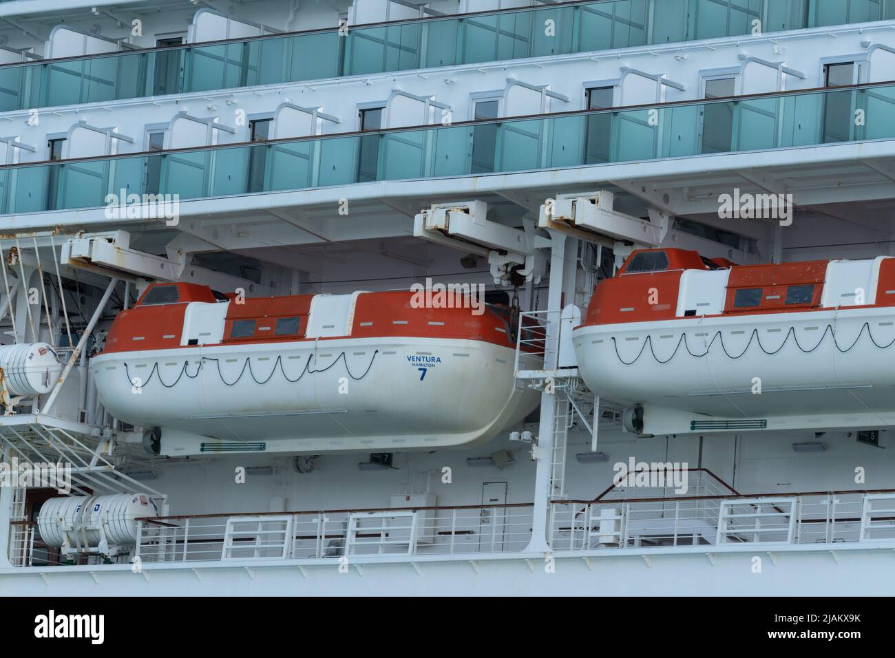 A row of lifeboats stowed on the side of a cruise liner Stock Photo - Alamy