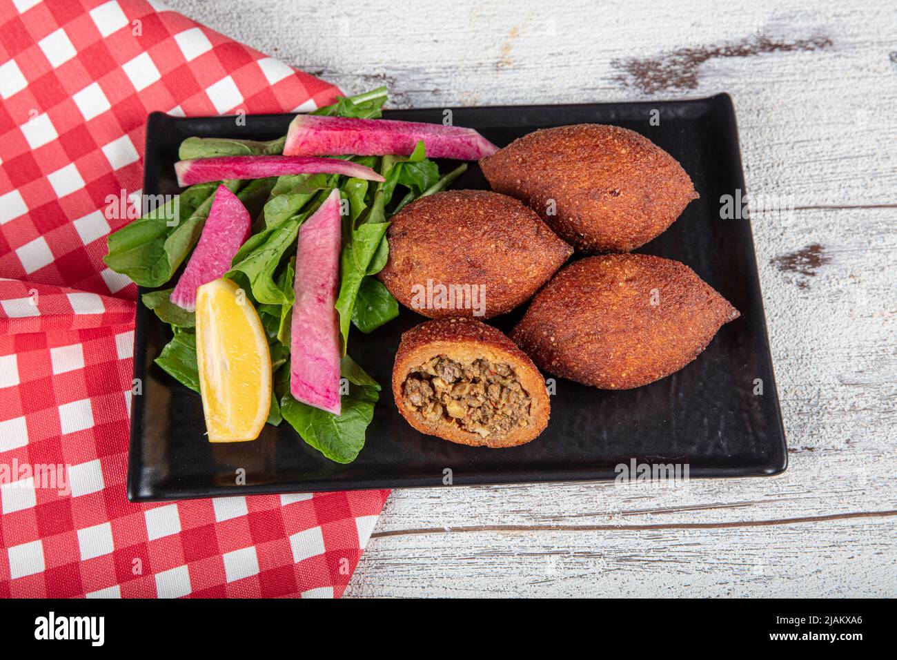 Kibbeh on a white wood background. Kibbeh is a popular dish in Middle ...