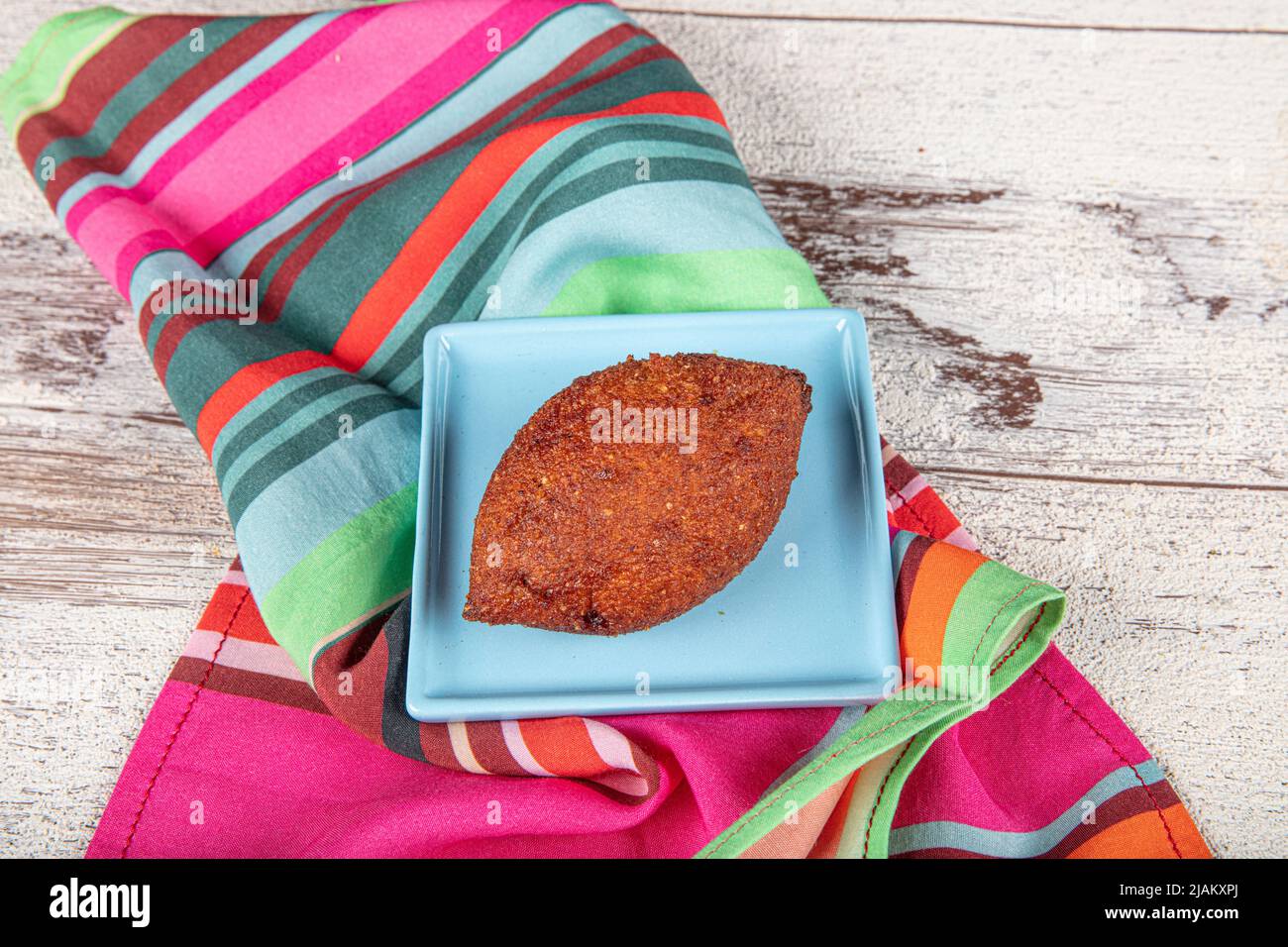 Kibbeh on a white wood background. Kibbeh is a popular dish in Middle ...
