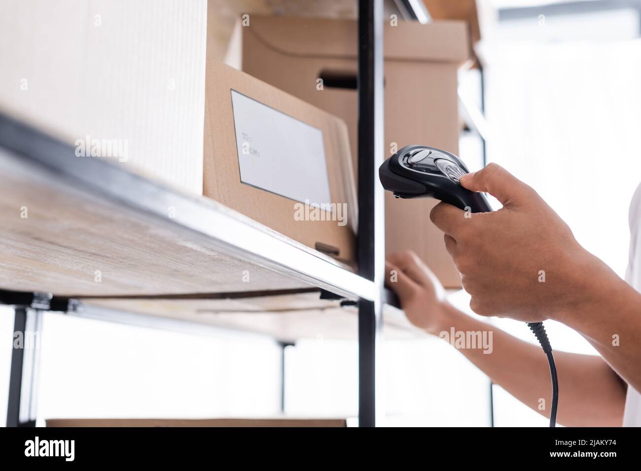 Cropped view of african american seller scanning shipping label on ...