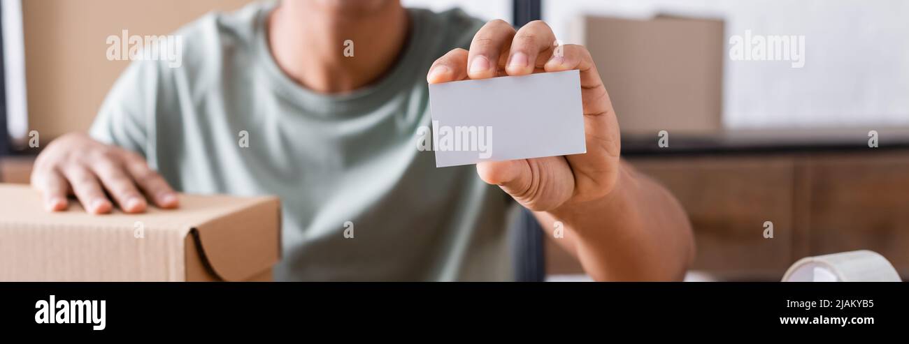 Cropped view of african american seller holding business card near ...