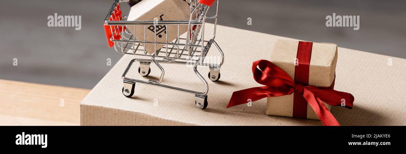 Toy cart near present on carton box, banner Stock Photo - Alamy