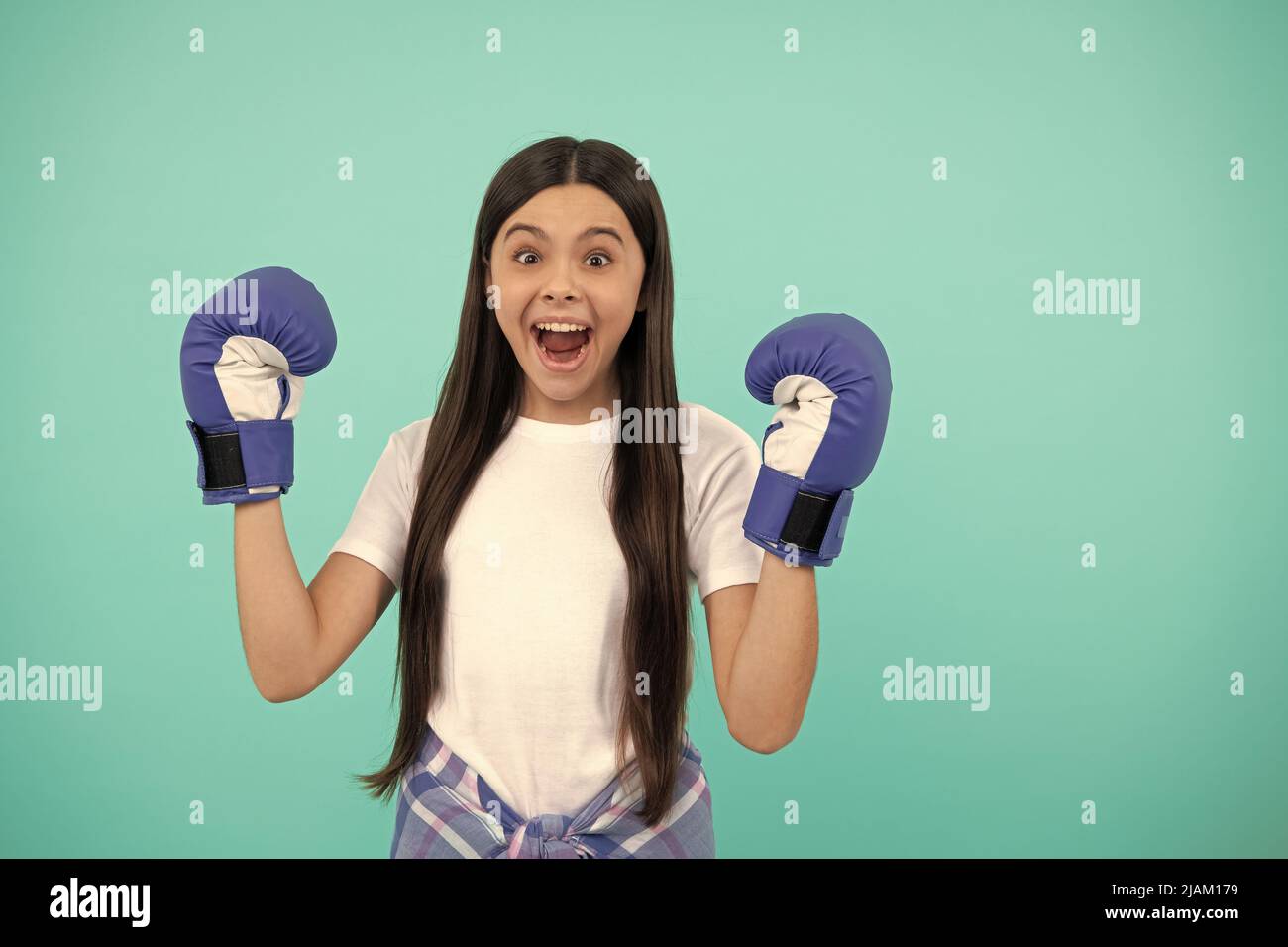 happy child boxer celebrate success in boxing gloves during sport ...