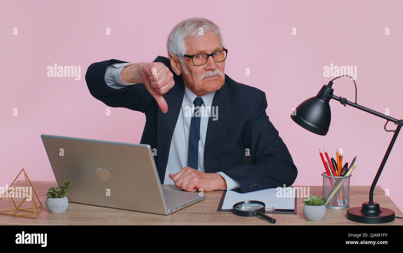 Upset senior mature business man showing thumbs down sign gesture ...