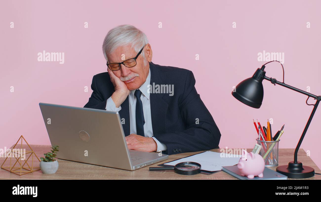Tired sleepy senior business man falling asleep sit at office desk with ...