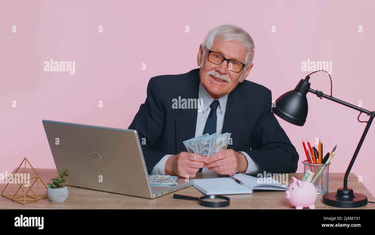 Senior business man accountant or banker making calculations at ...